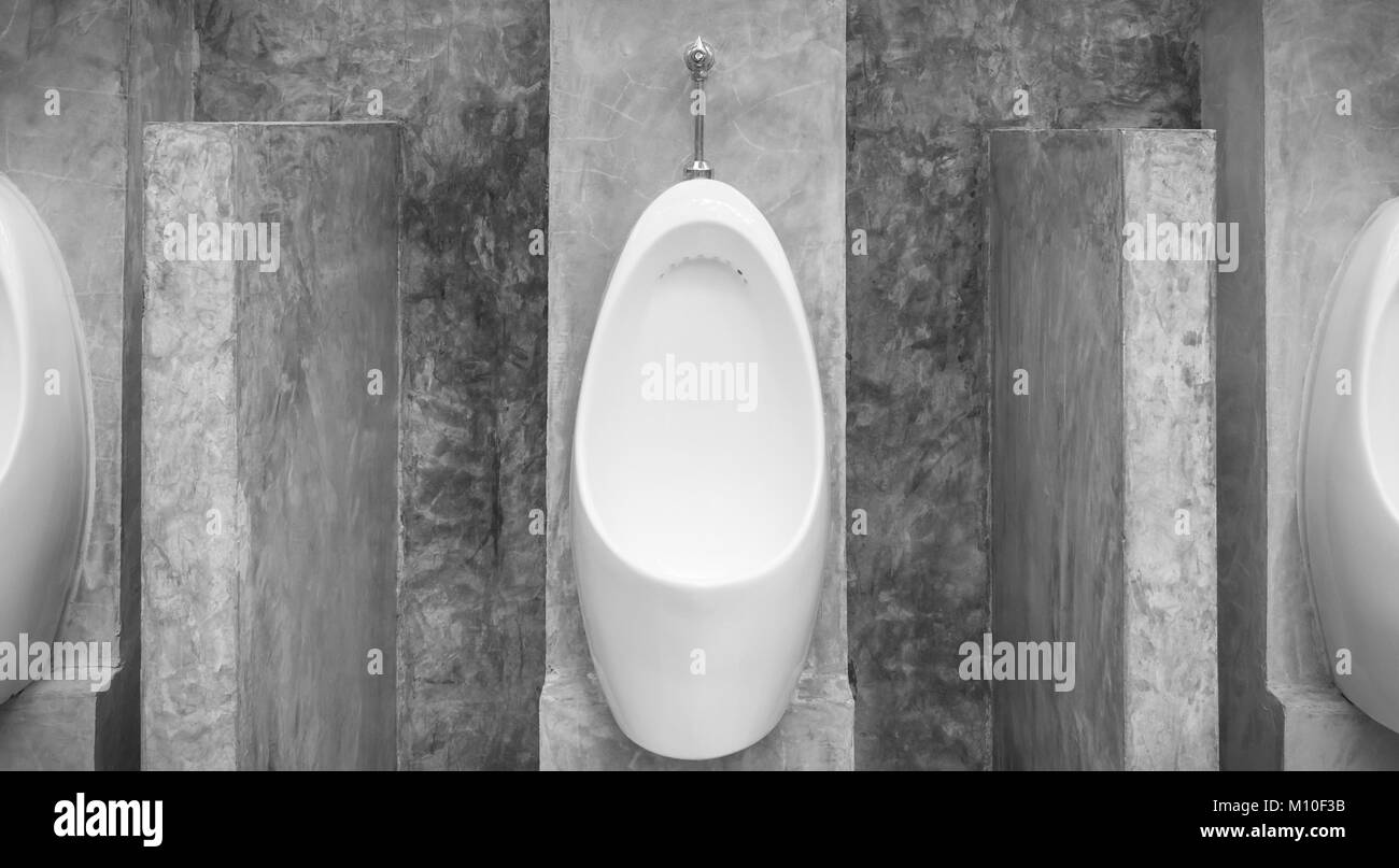 White urinal men with concrete wall loft style for interior design or ...