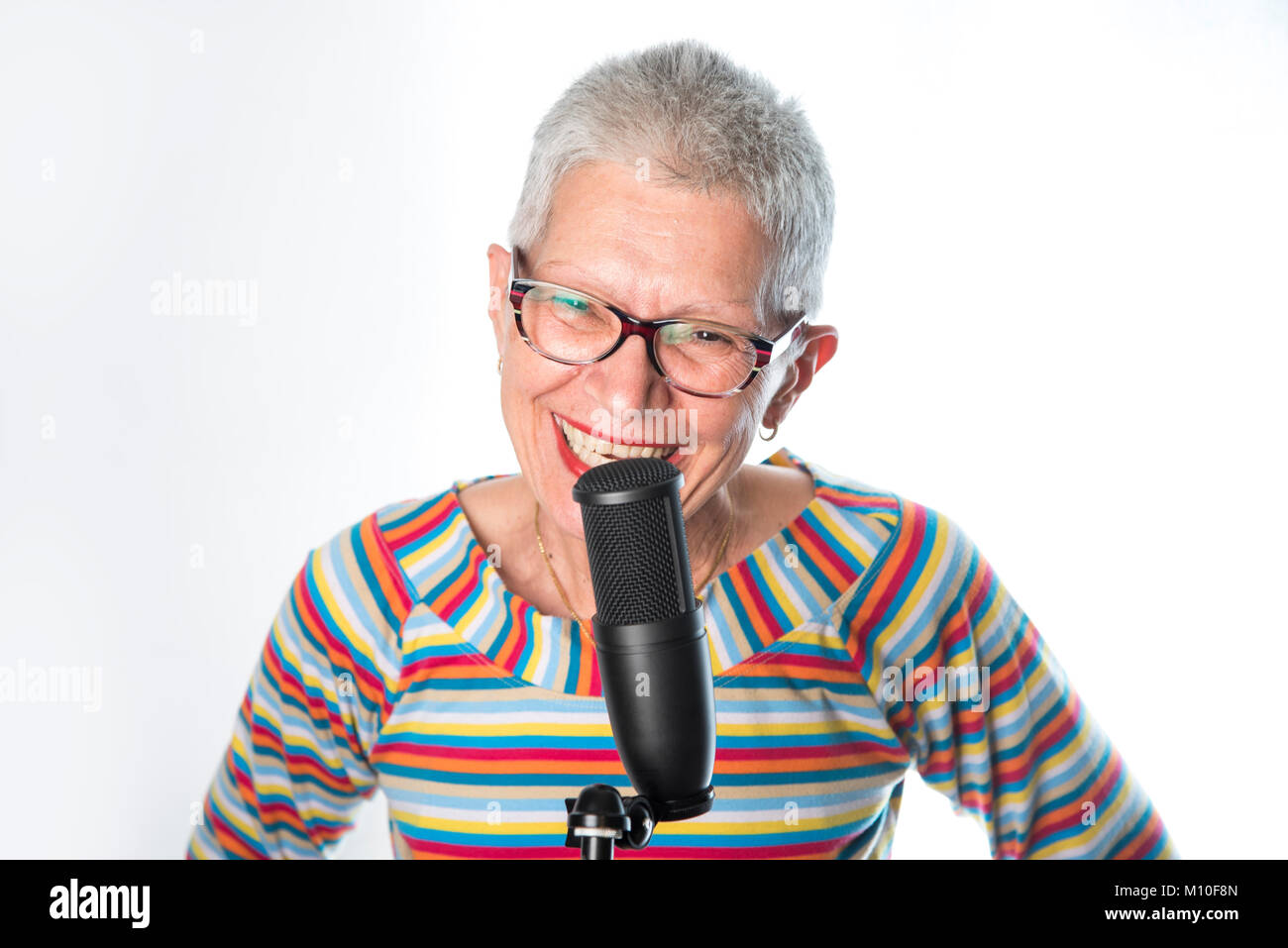 Senior old woman singing on a professional microphone Stock Photo - Alamy