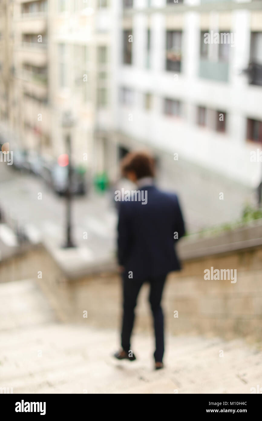 Handsome mix blood man walking down steps with newspaper Stock Photo ...