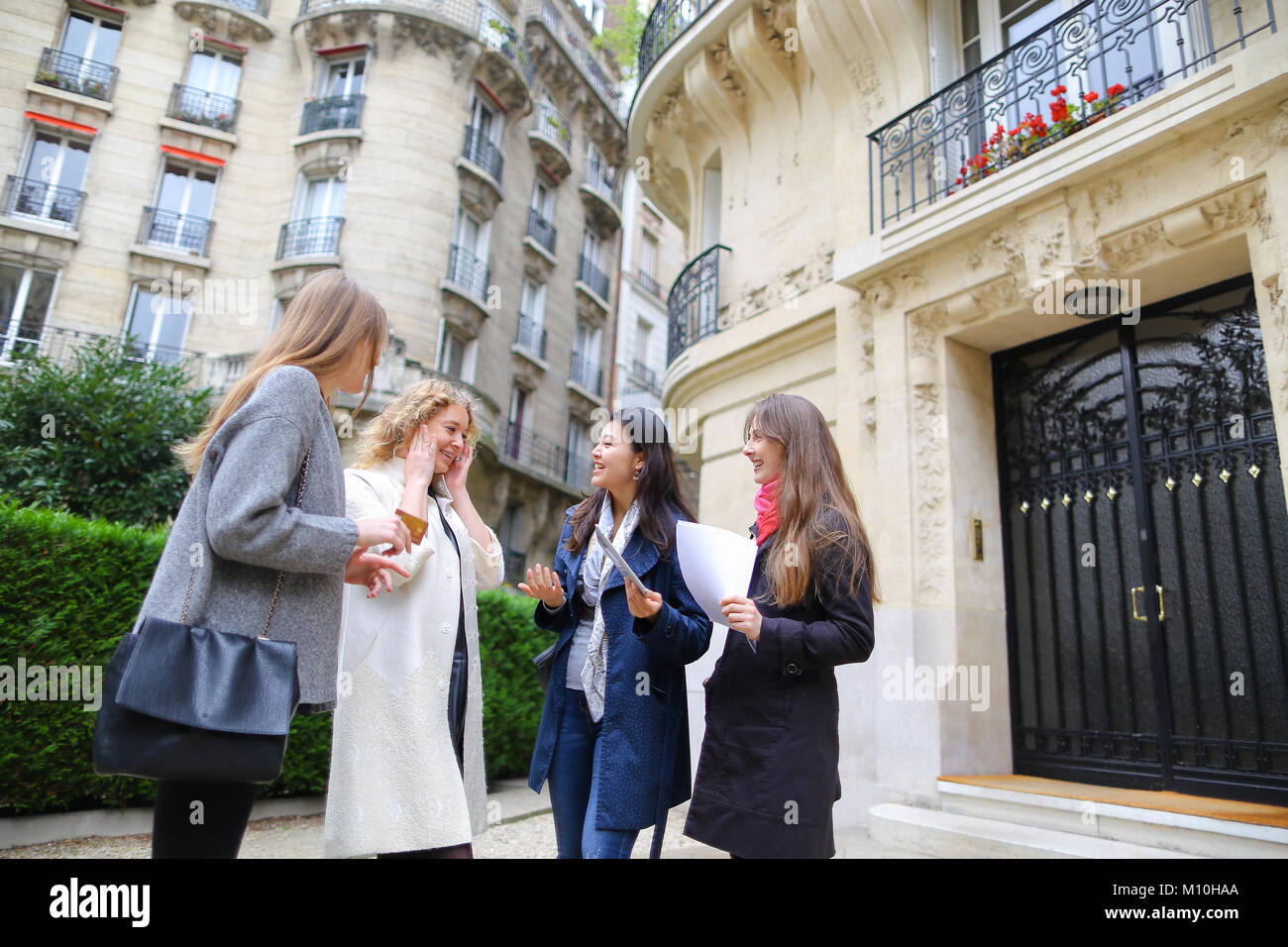 Happy female students talking outside in near university build Stock ...