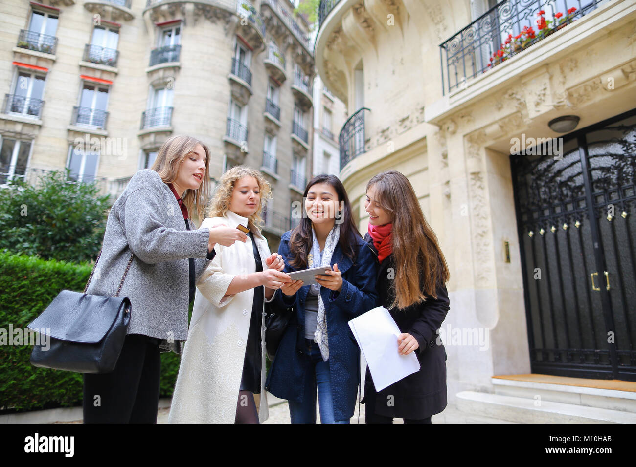 Happy female students talking outside in near university build Stock ...