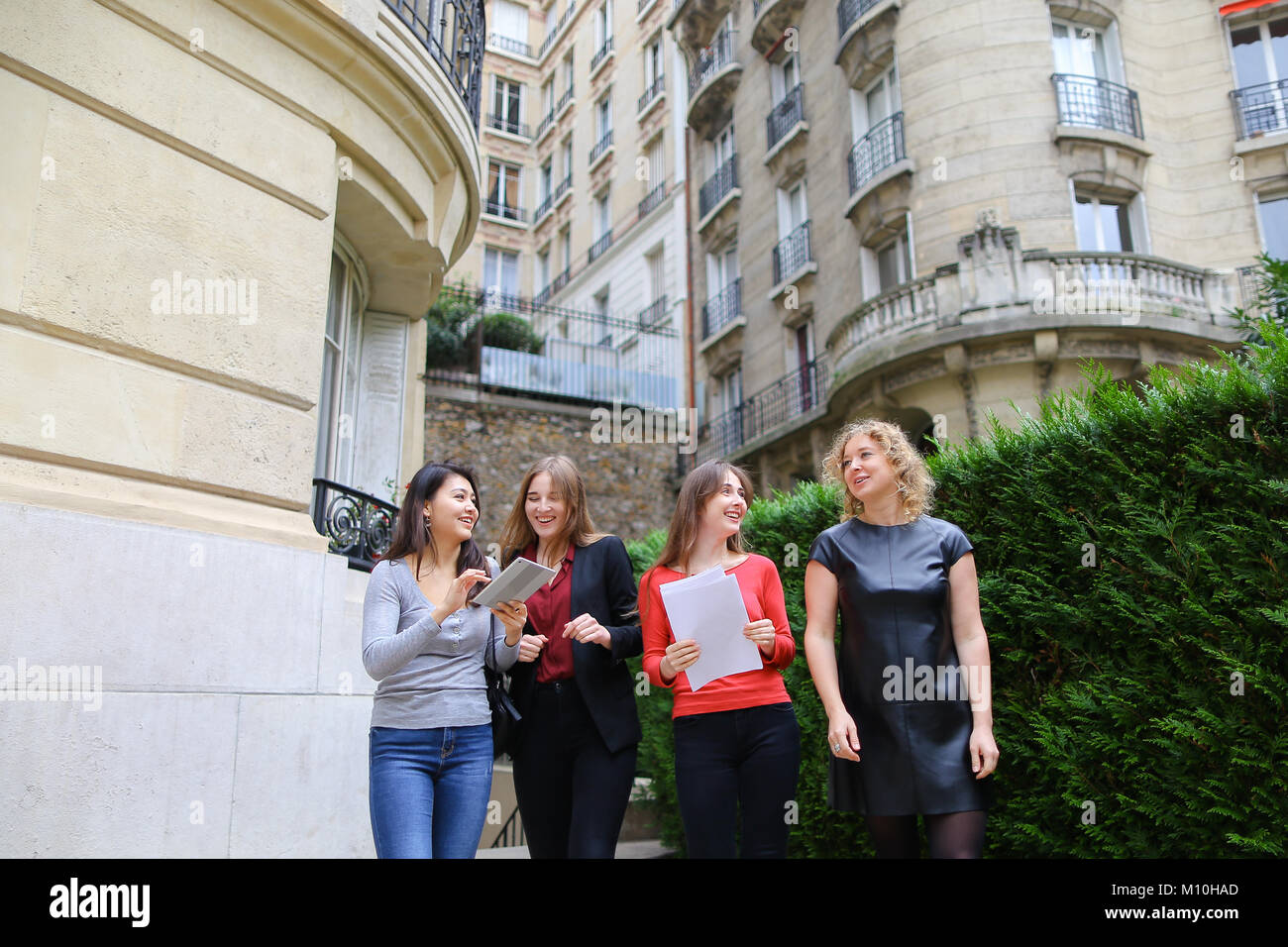 Professor talking with new students near university building in Stock ...
