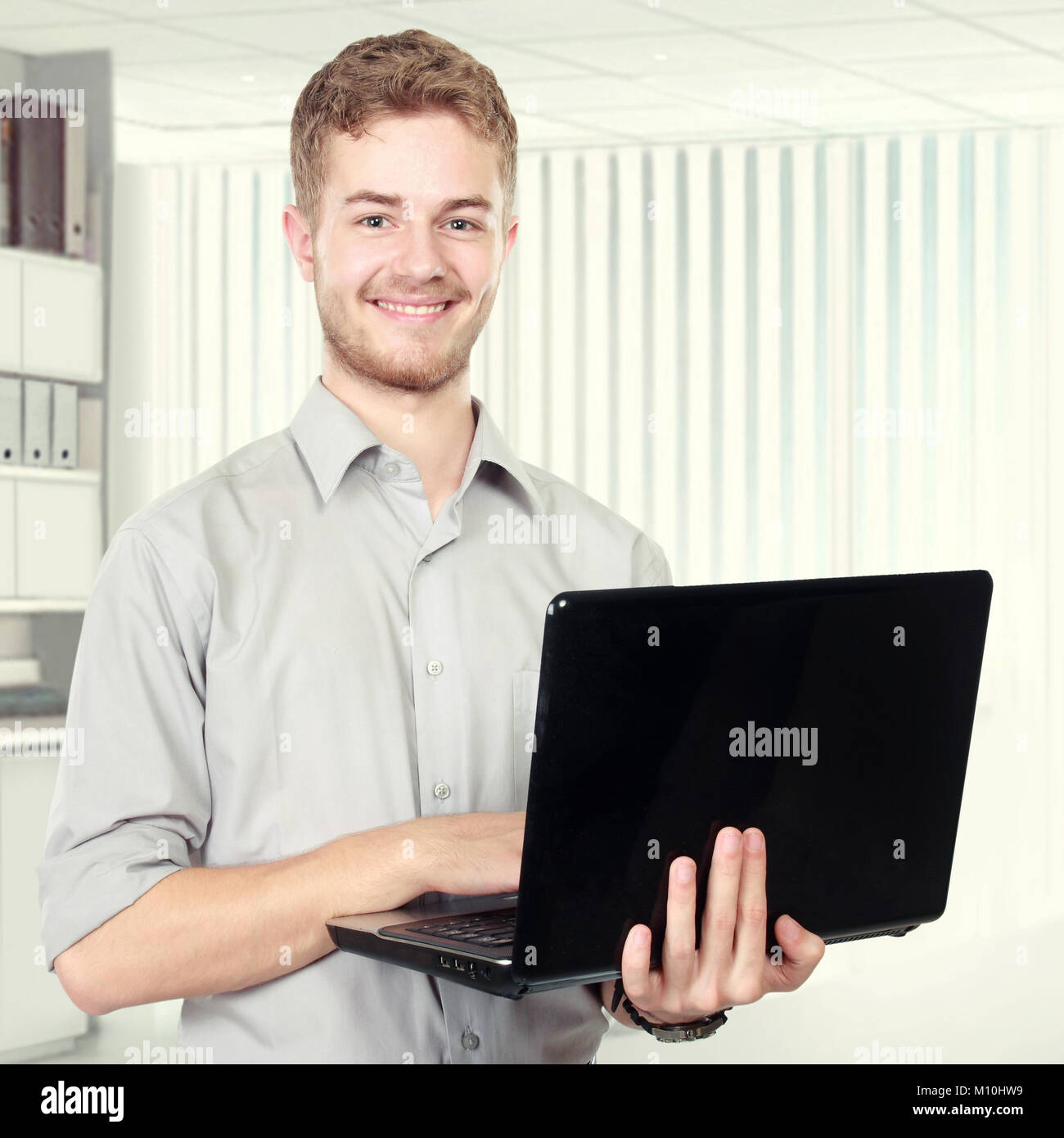 portrait of Young businessman using laptop pc in the office Stock Photo ...