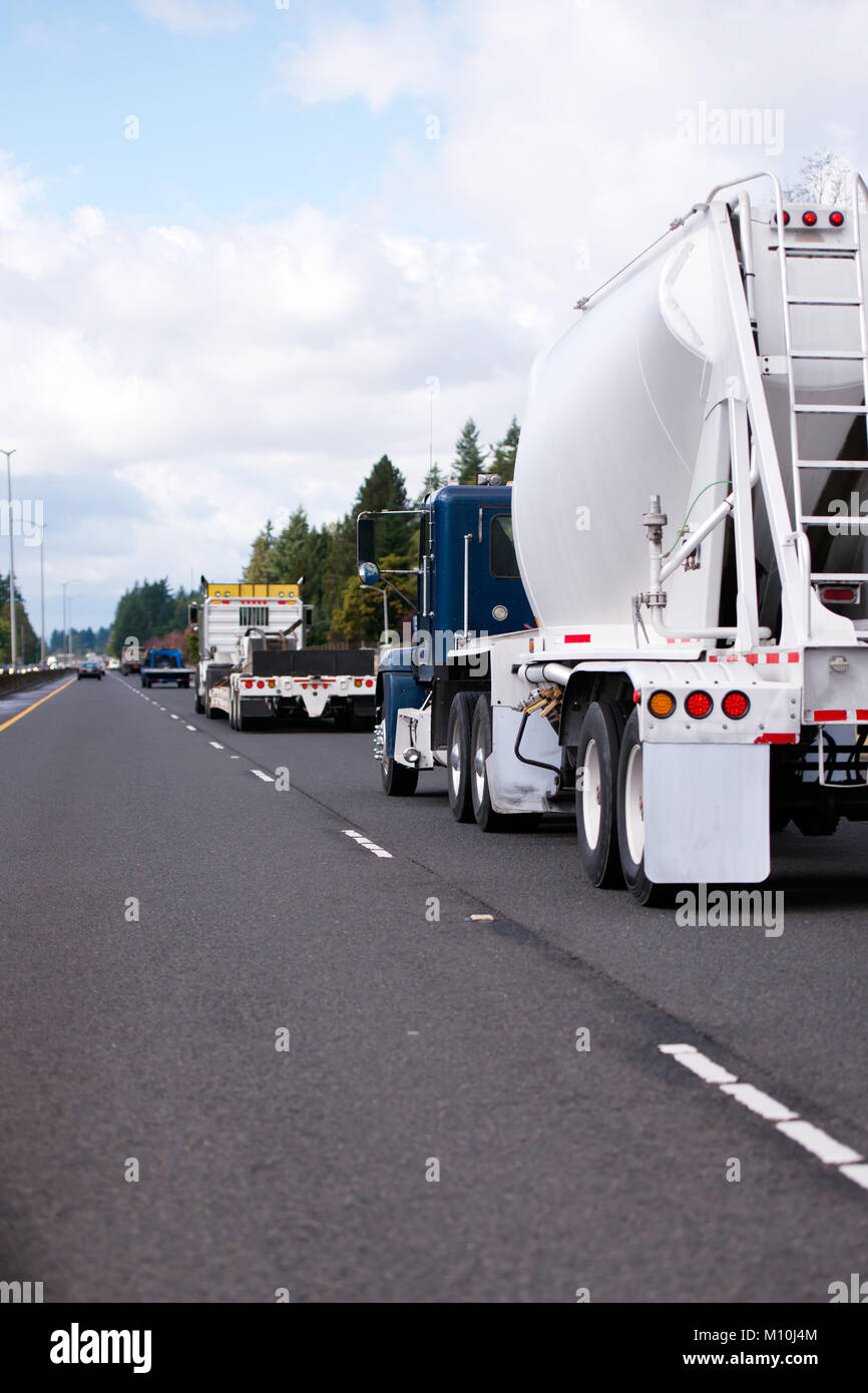 Convoy of big rig semi trucks with day cabs for local freight and ...