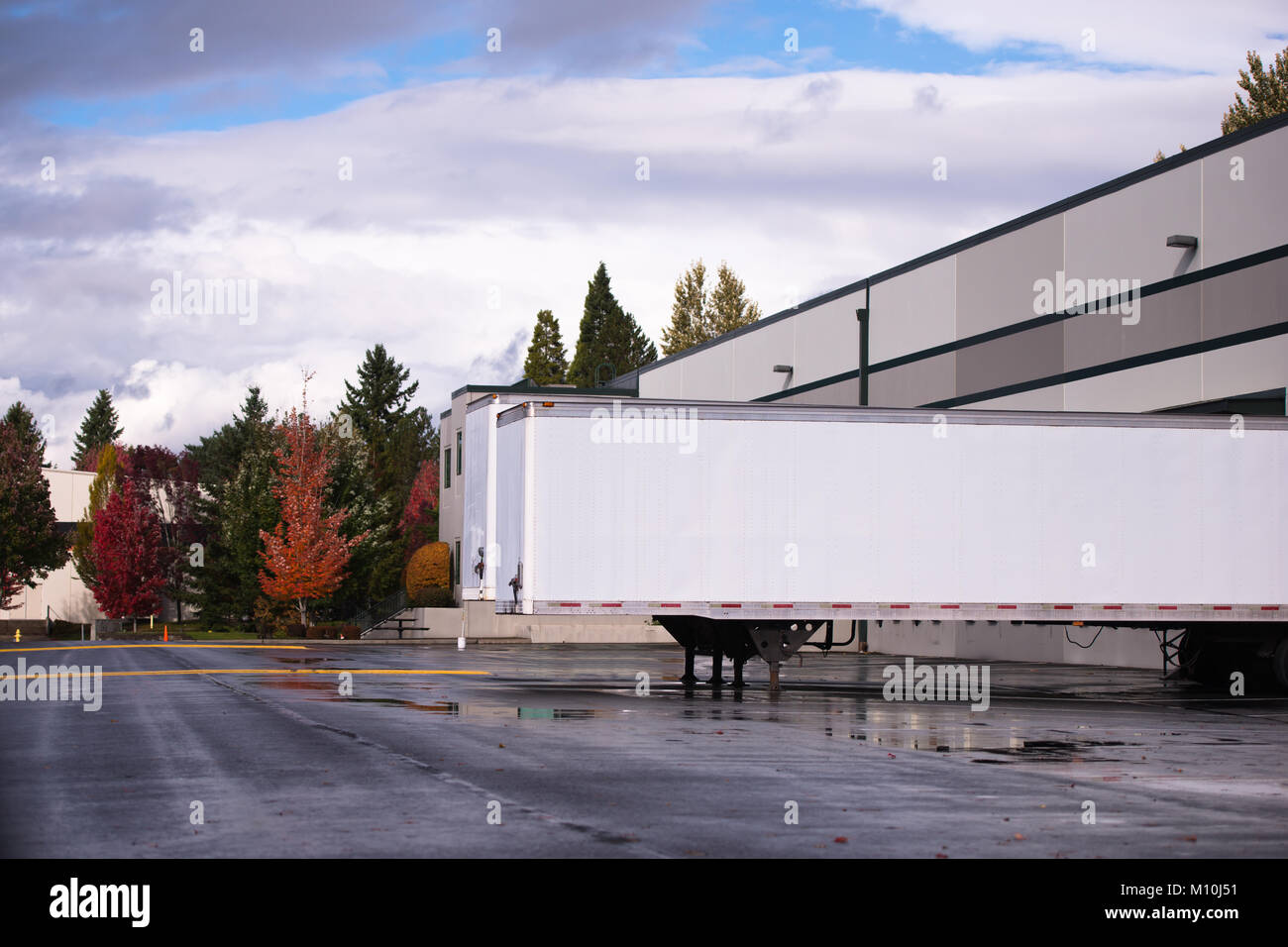 Unhooked long dry van semi trailers stand side by side for loading and ...