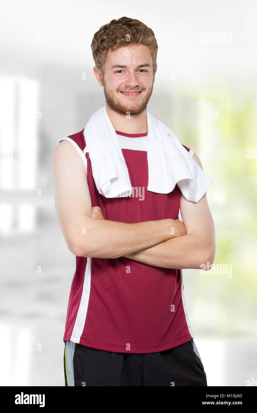 Healthy lifestyle. Smiling man after doing some work out at the gym ...