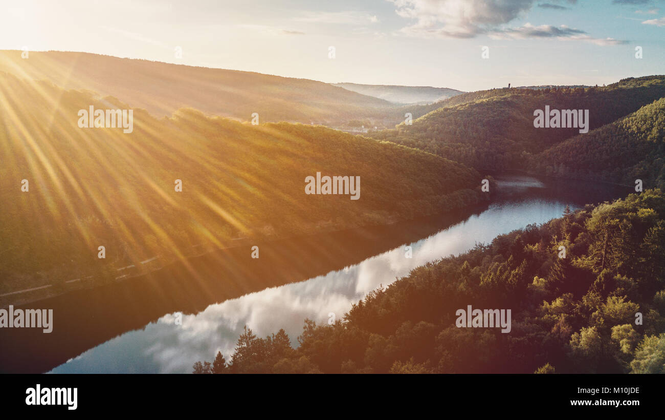 Bird's eye view over beautiful landscape with a lake and green forest ...