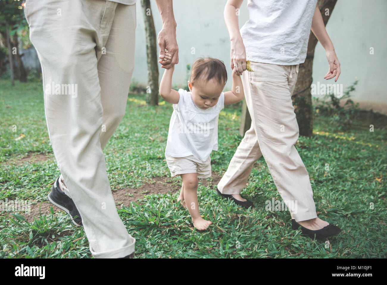 parent with their cute baby walking together in the park Stock Photo ...