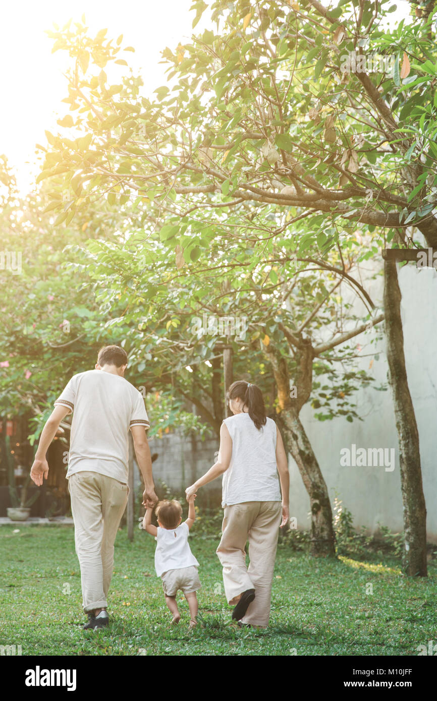 parent with their cute baby walking together in the park Stock Photo ...