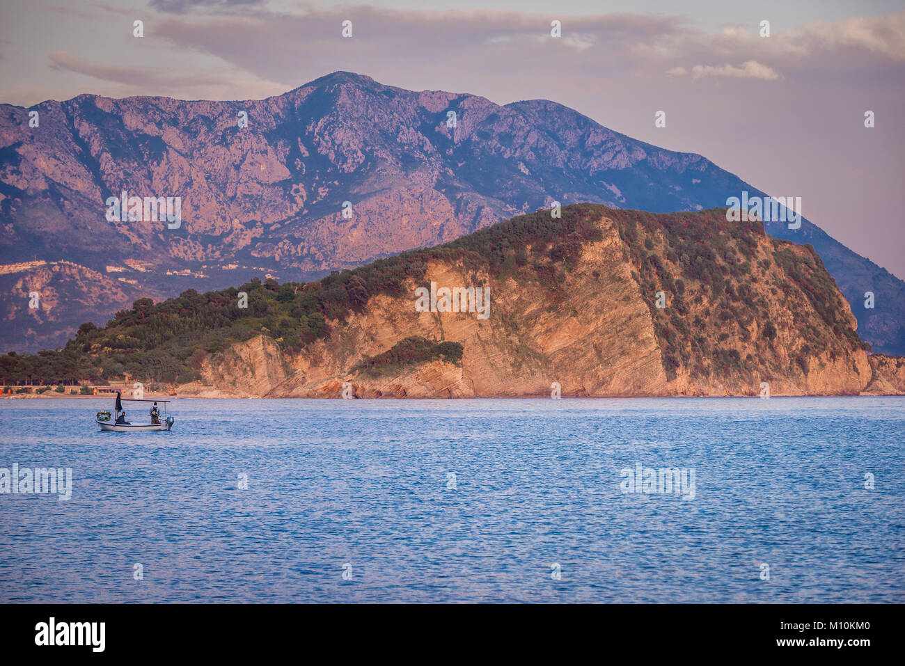 Sunset over Sveti Nikola Island in Budva city on the Adriatic Sea coast ...