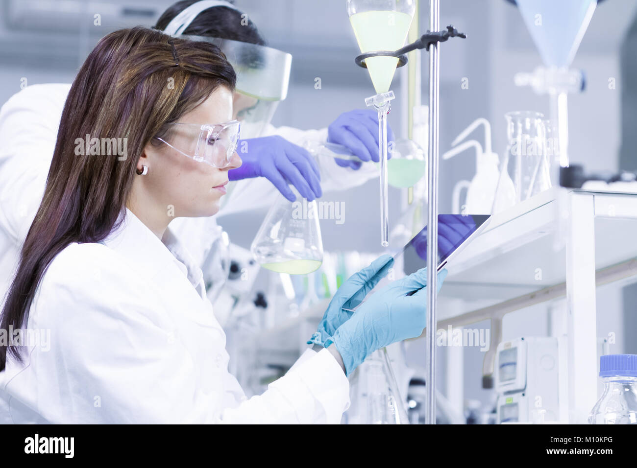 Chemical laboratory research. PhD researcher student and her post ...