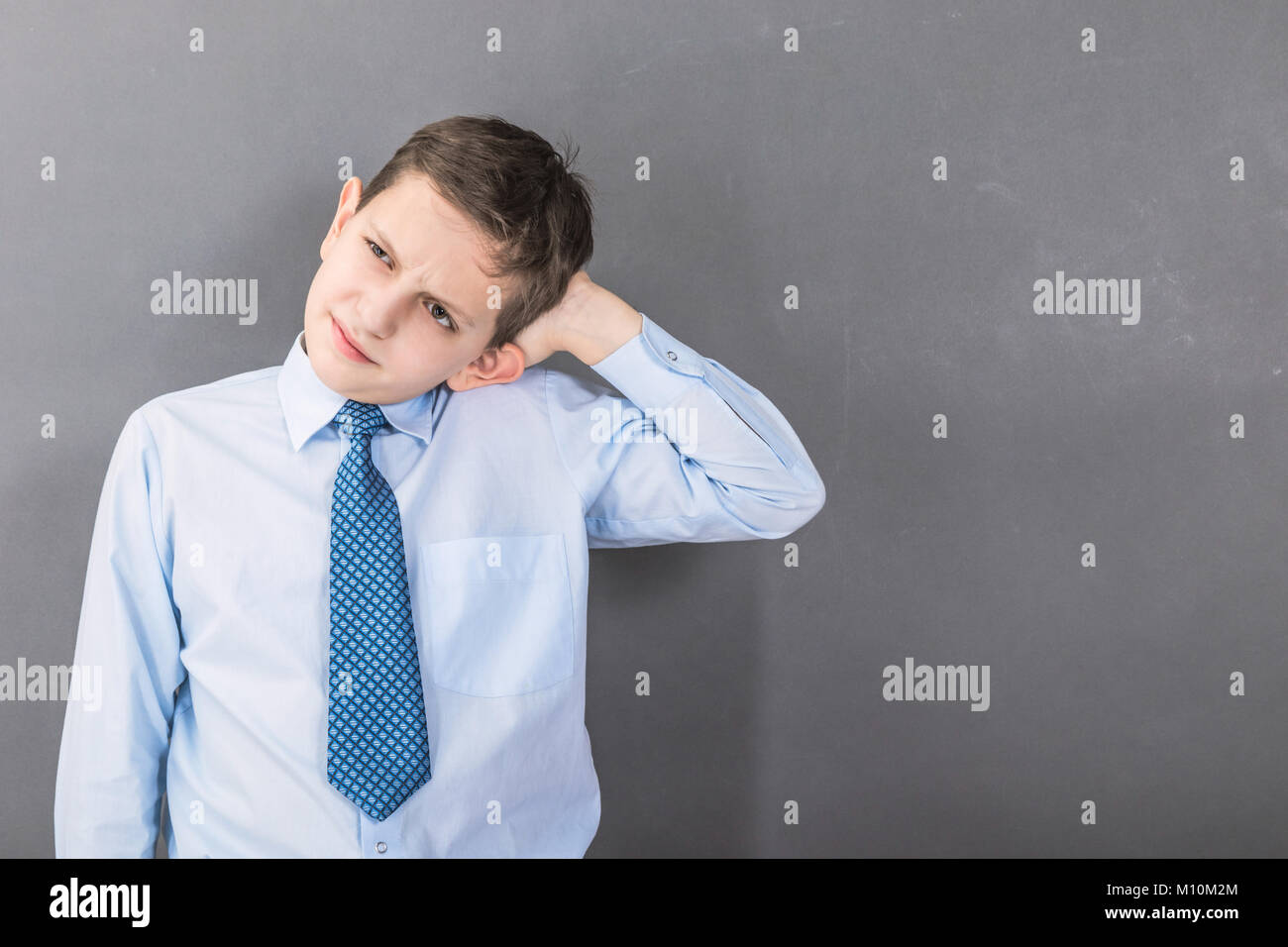 Unconfident boy student before dark background with copy-space as a ...