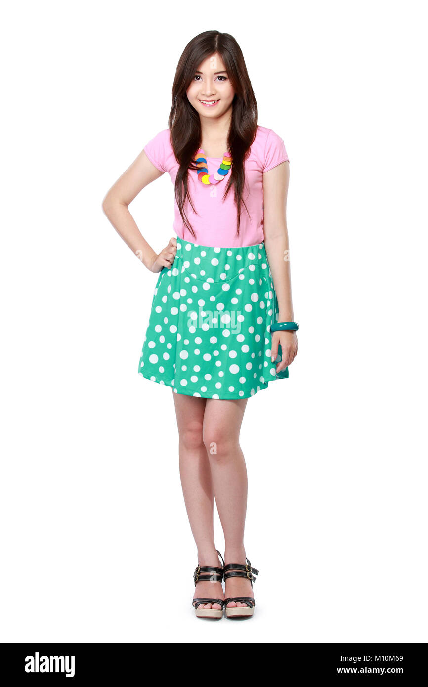 attractive young asian woman standing isolated over white background ...