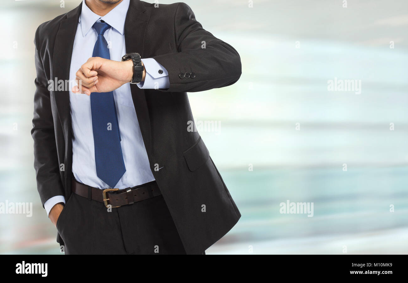 portrait of busy business man body looking at his watch in rush hour ...