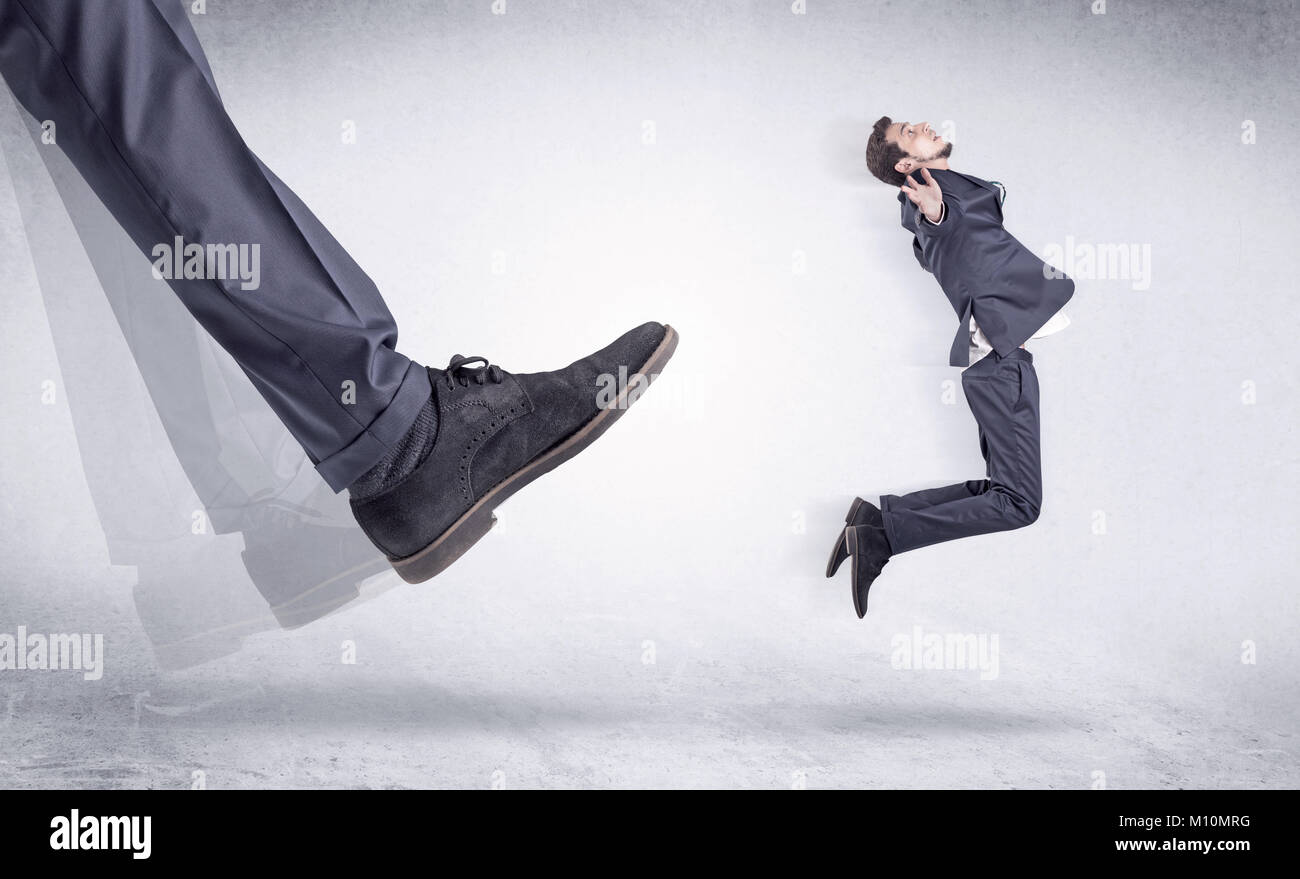 Boss mobbing his worker, illustrated by black shoe kicking small ...
