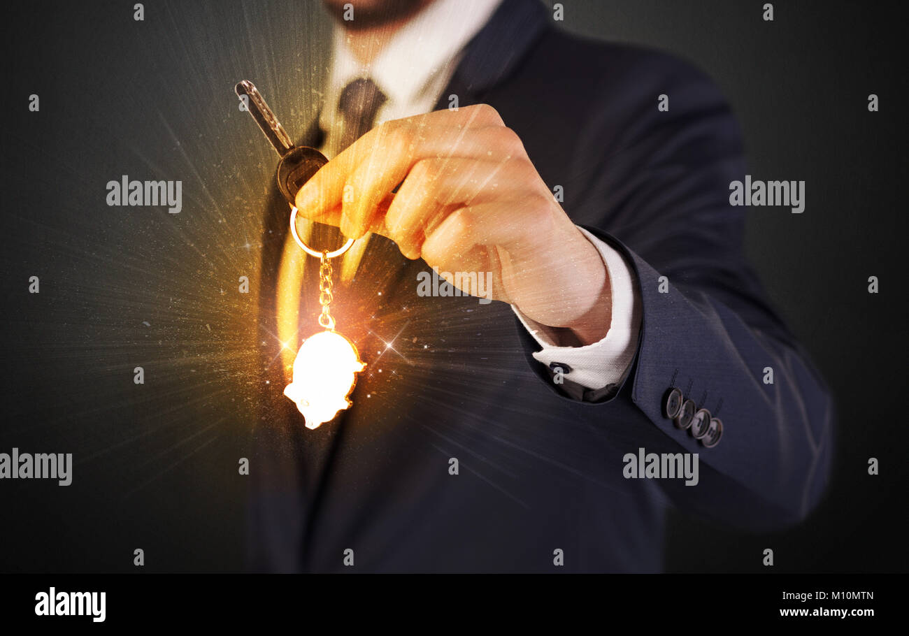 Formal man hand over shiny keys with dark background Stock Photo - Alamy