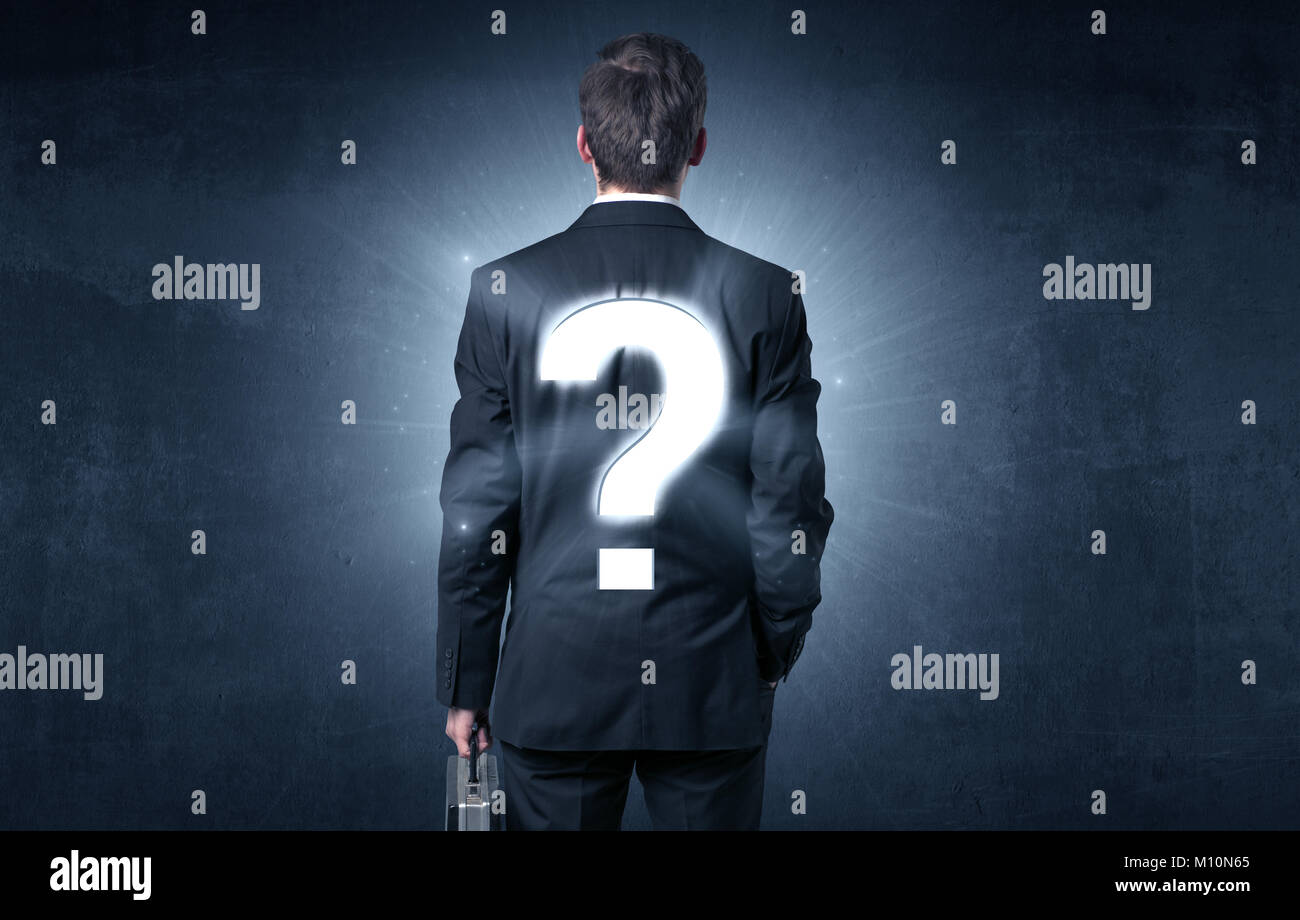 Businessman standing and thinking about questions Stock Photo - Alamy