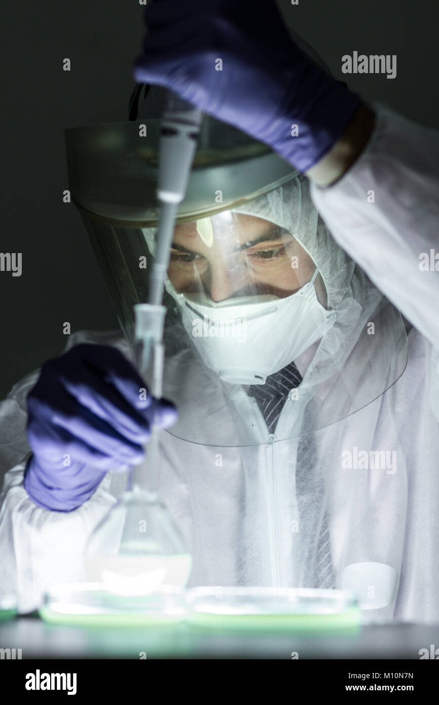 Life scientist researching in bio hazard laboratory. Focused life ...