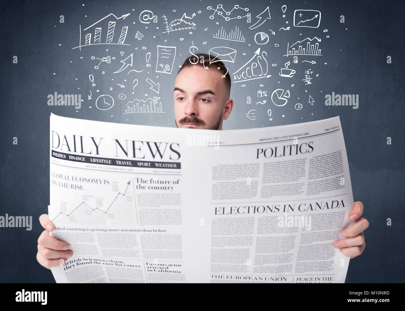 Young smart businessman reading daily newspaper with business plan ...