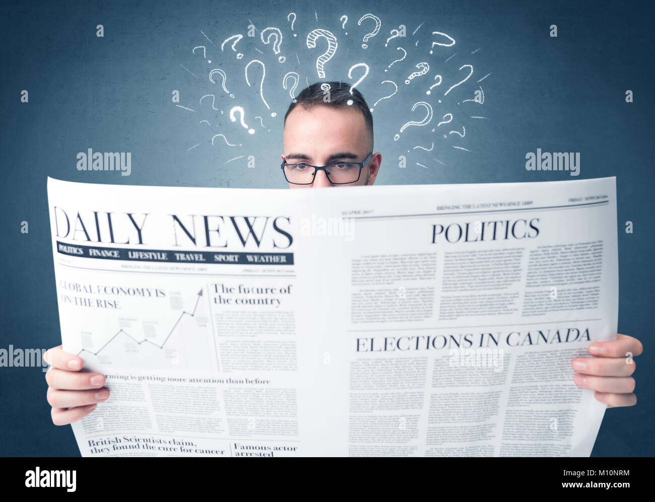 Young confused businessman reading daily newspaper with question marks ...
