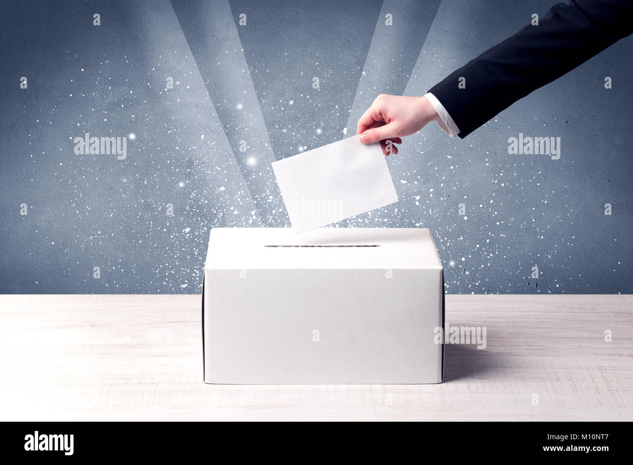 Ballot box with person casting vote on sparkling background Stock Photo ...
