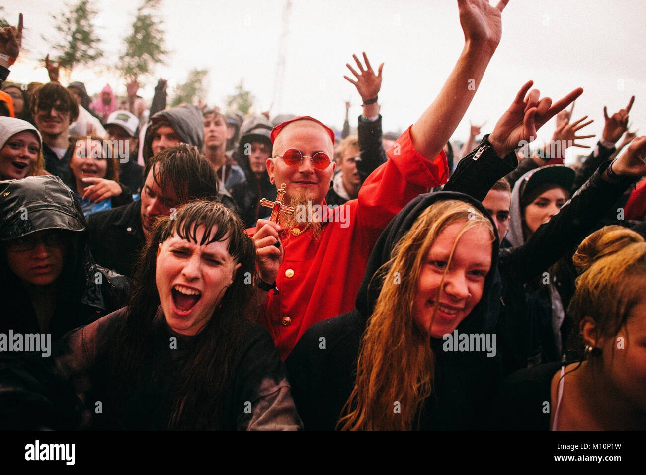 Enthusiastic and energetic music fans go crazy at a concert with the ...