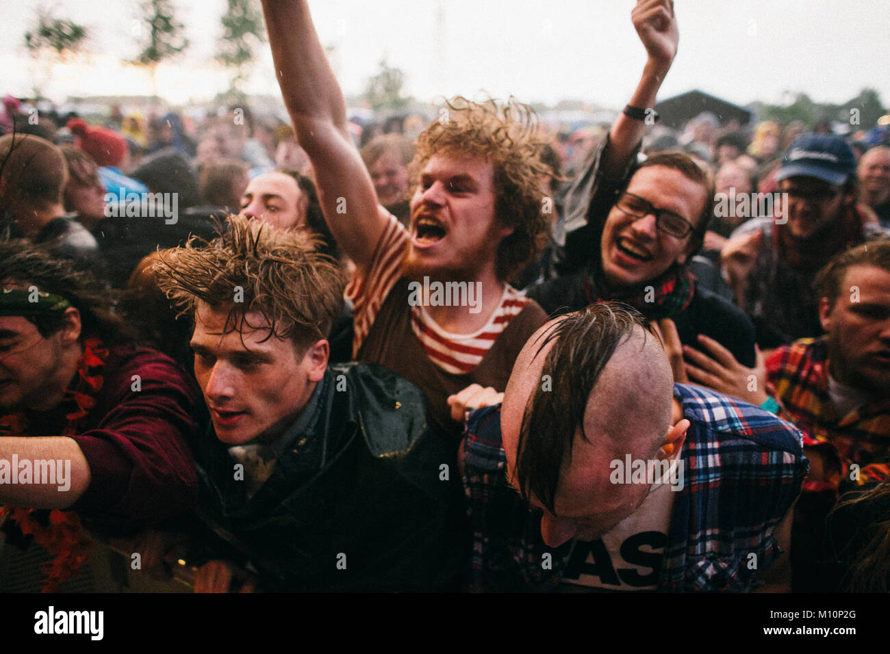 Enthusiastic and energetic music fans go crazy at a concert with the ...