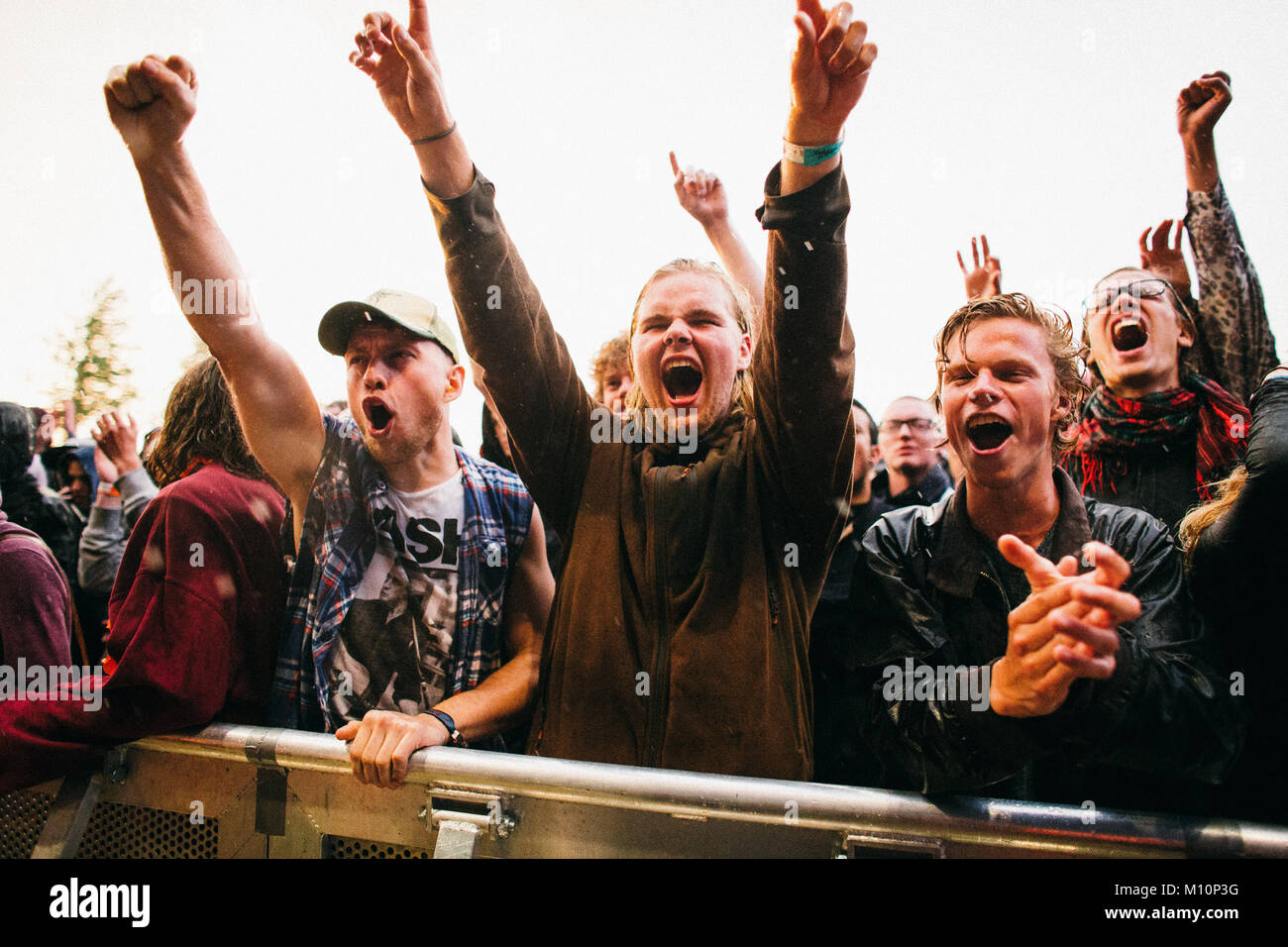Enthusiastic and energetic music fans go crazy at a concert with the ...