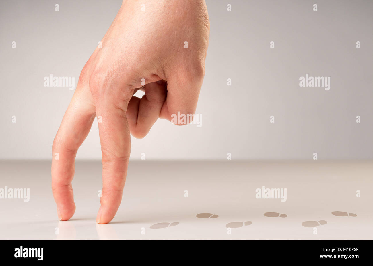 Female fingers walking on white surface with footsteps behind it Stock ...