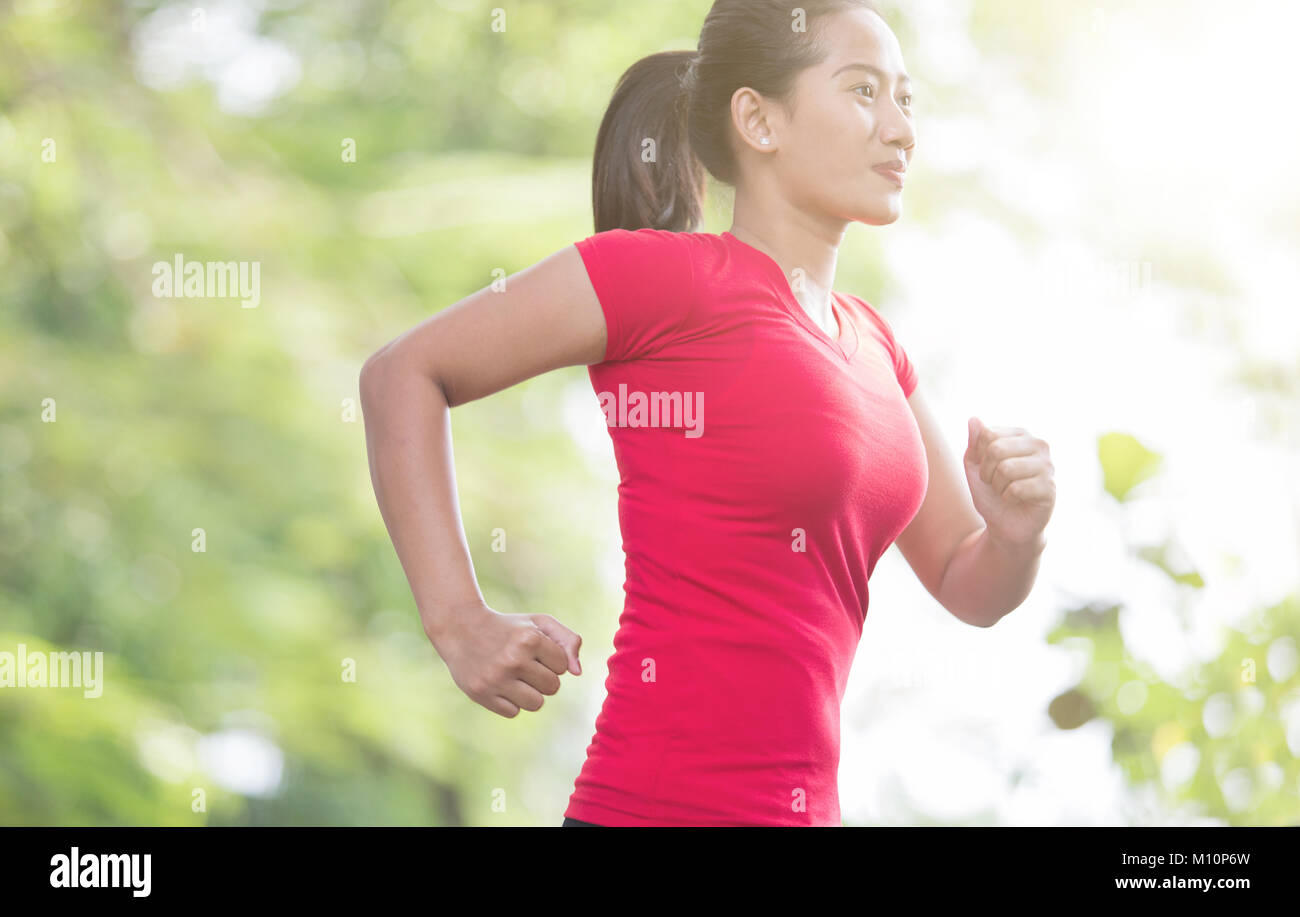 A portrait of a young asian woman jogging at the park Stock Photo - Alamy