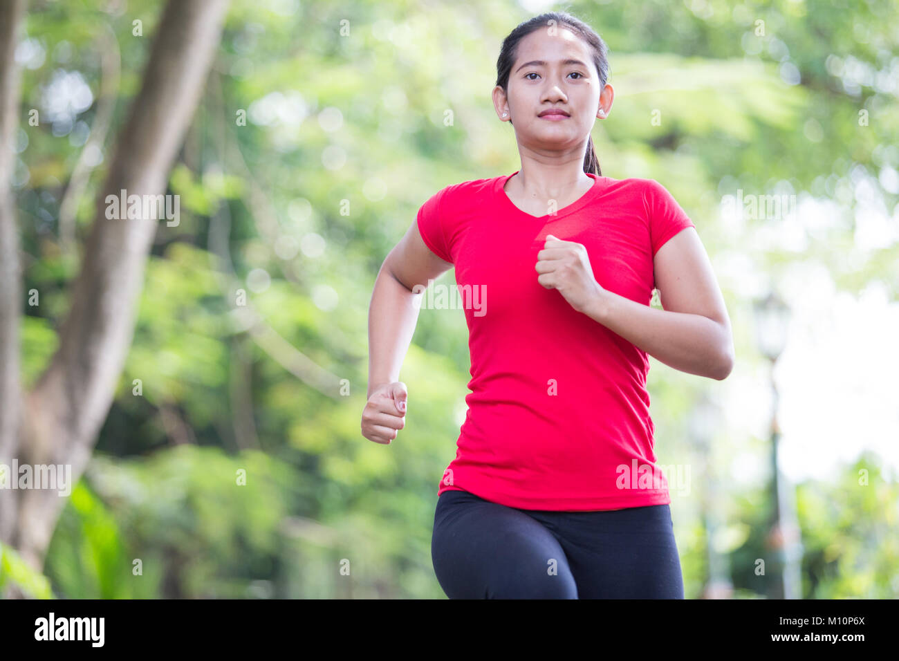 Portrait of a young asian woman jogging at the park Stock Photo - Alamy