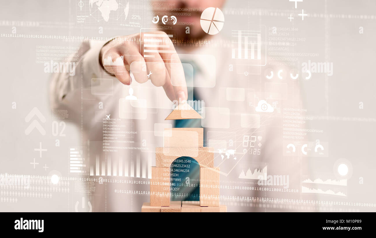 Young handsome businessman using wooden building blocks with mixed data ...
