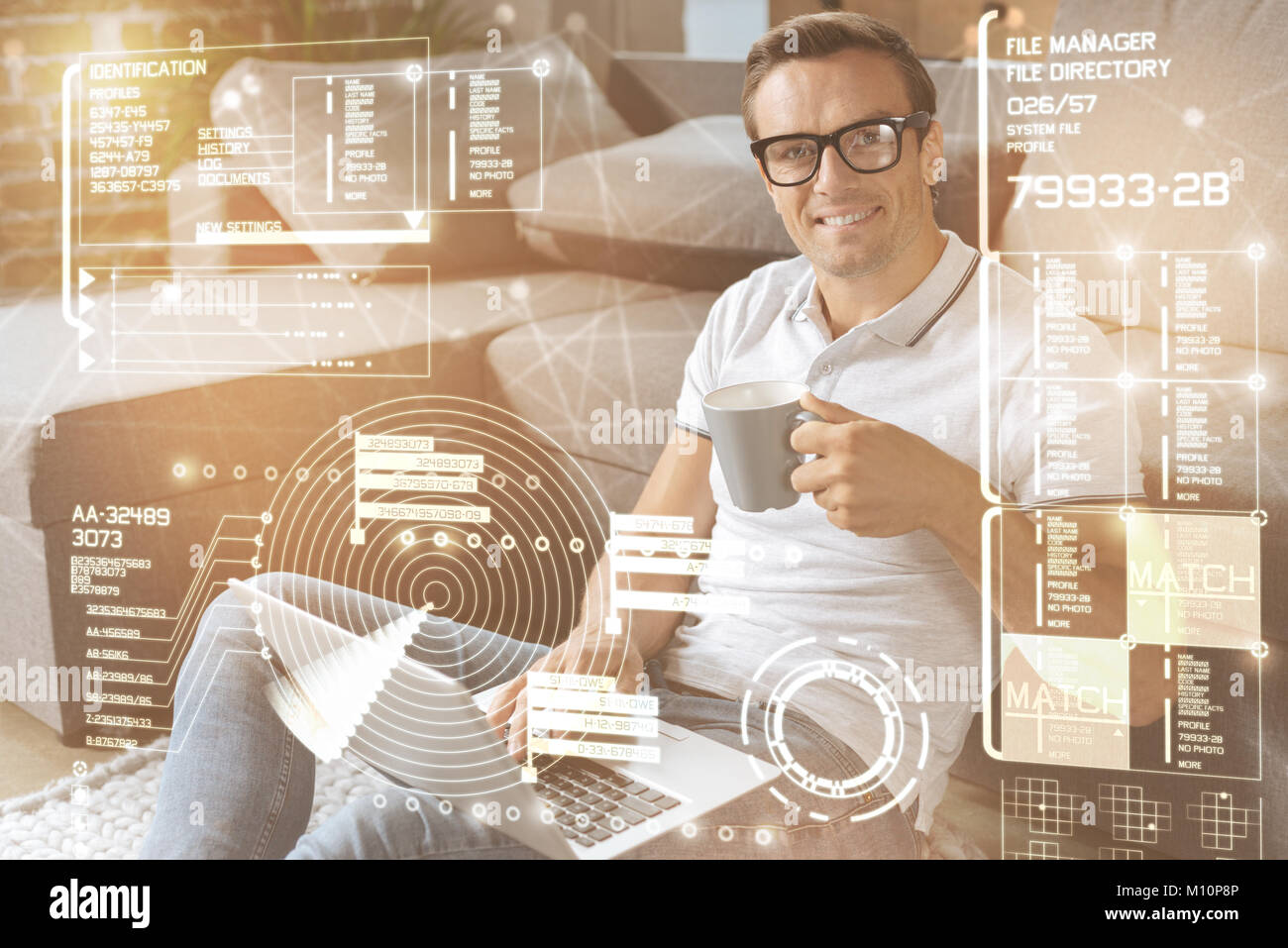 Cheerful man using his laptop at home Stock Photo - Alamy