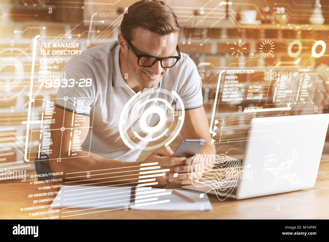 Cheerful man using his smart phone Stock Photo - Alamy