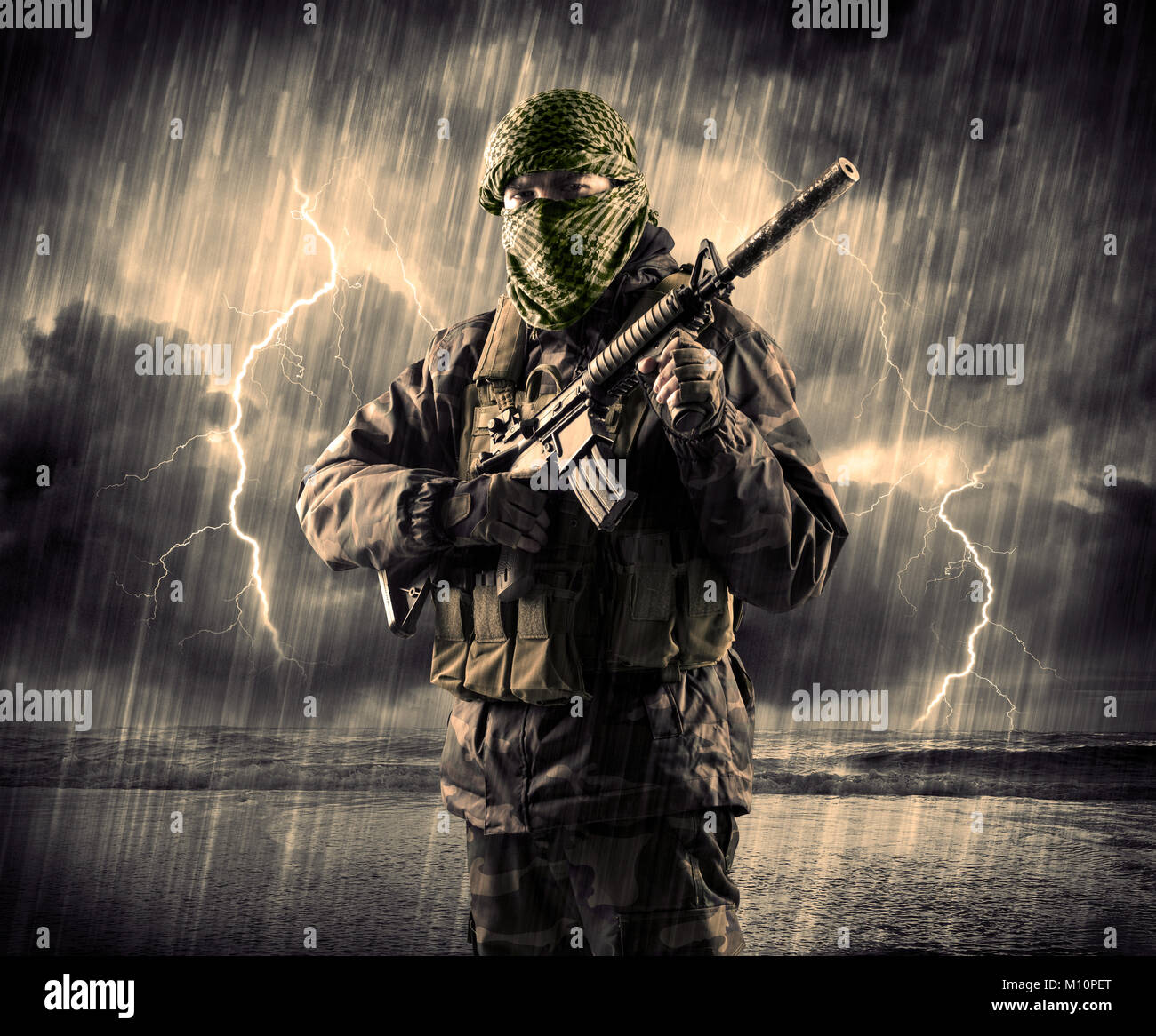 Portrait of a dangerous armed terrorist with mask and gun in a ...