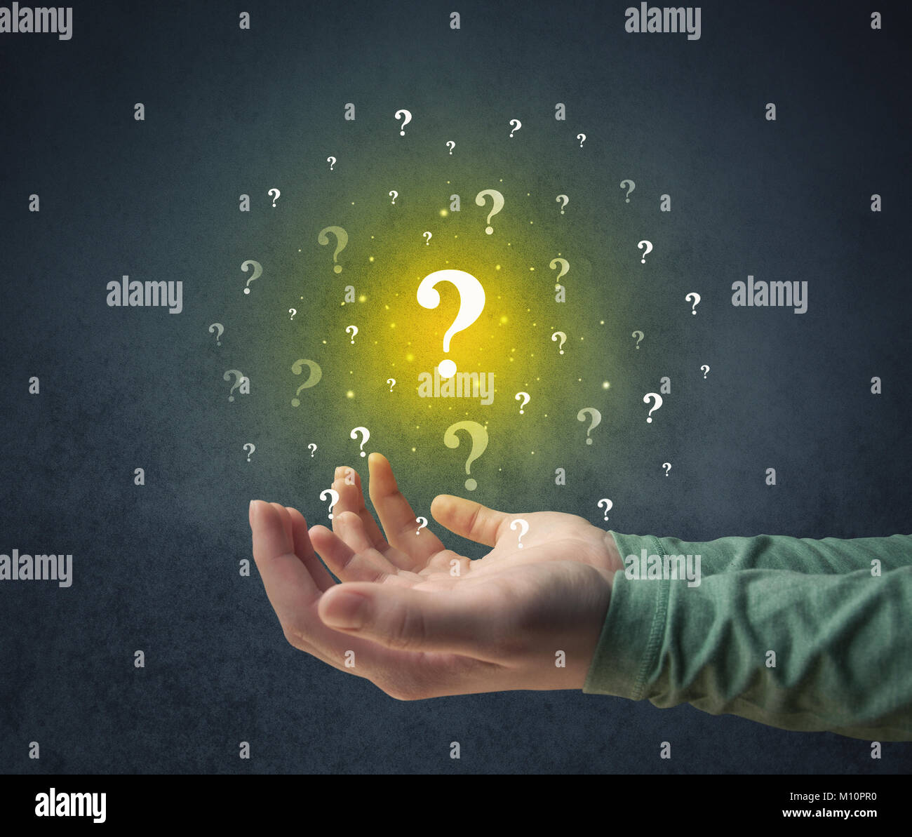 Yellow question marks hovering over young hand Stock Photo - Alamy