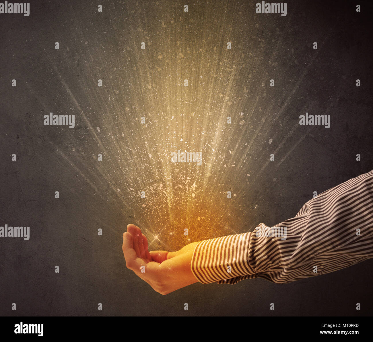 Yellow ray of light coming from a young hand Stock Photo - Alamy