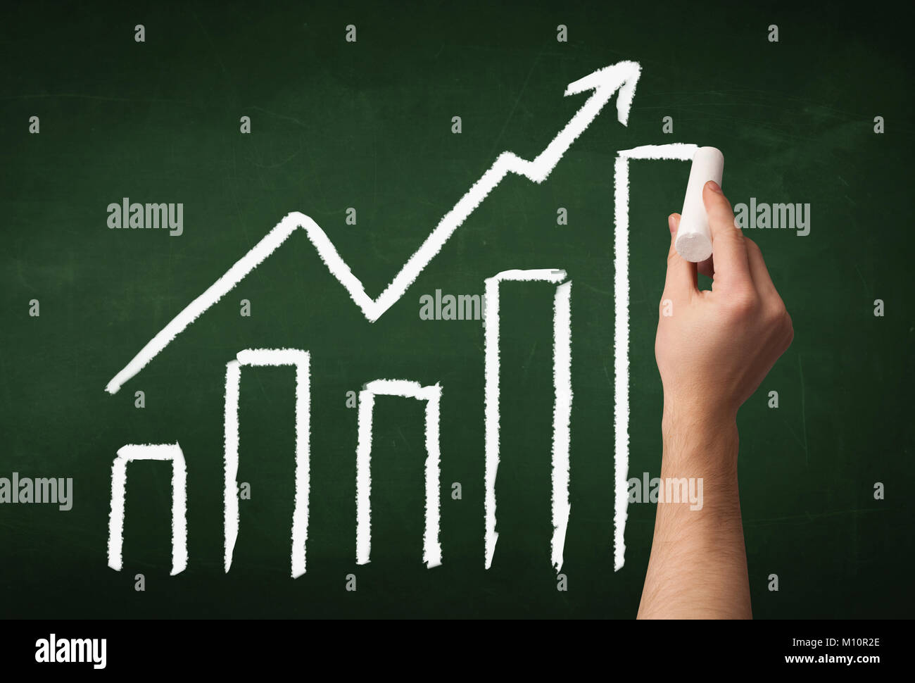 A grown up's hand drawing chart with exponentially growing arrow on ...