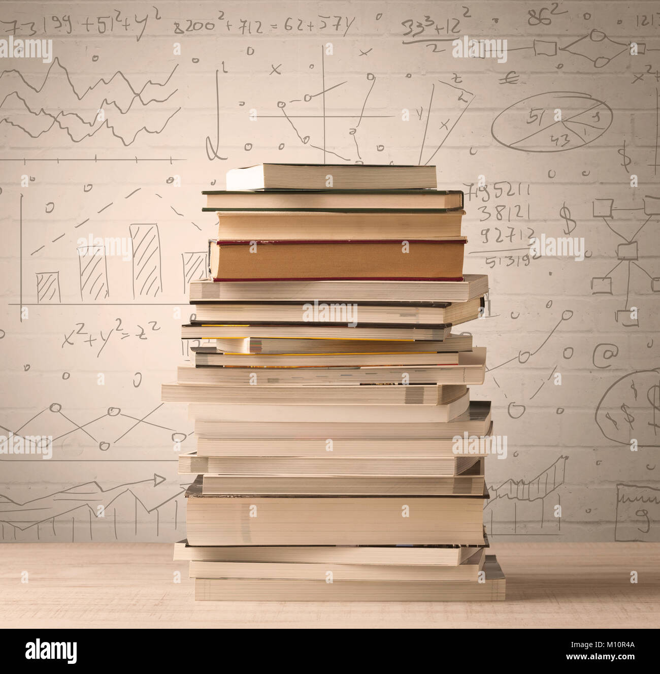 A pile of books with math formulas written in doodle style on ...