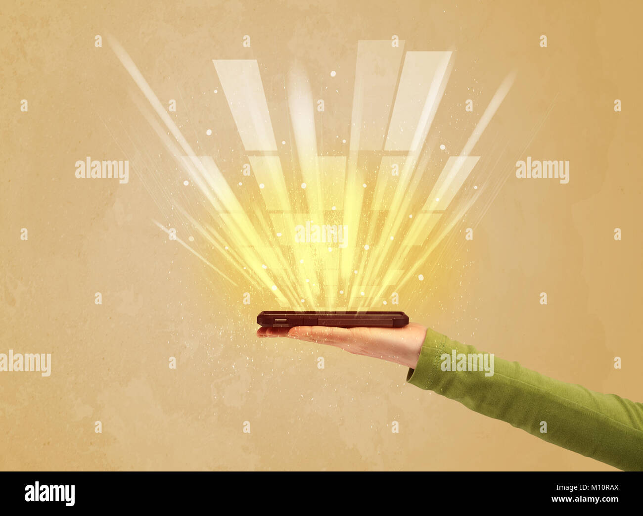 A caucasian hand holding a tablet phone with light beams and ...