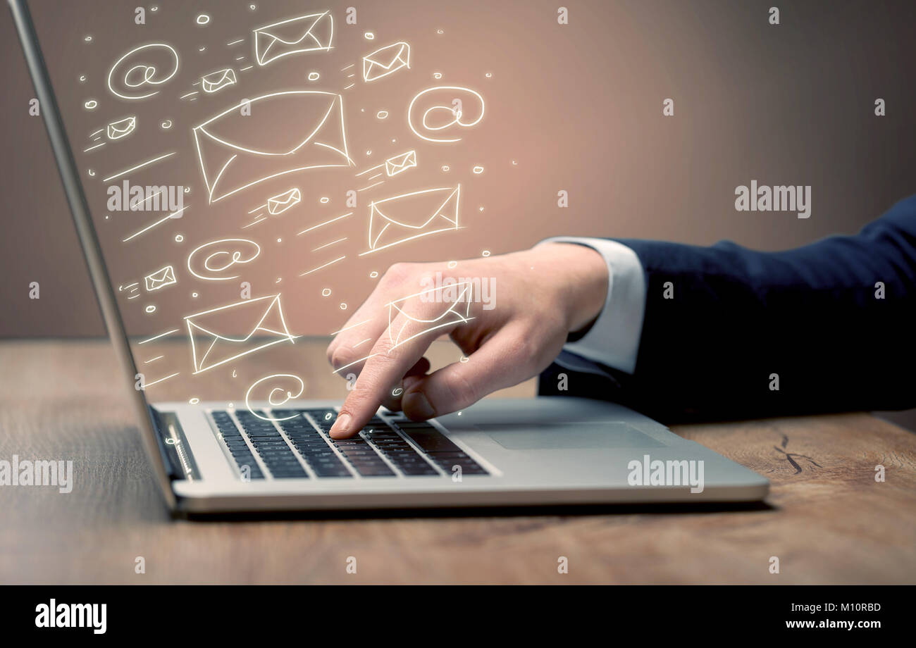 An office worker sending emails and communication with clients with the ...
