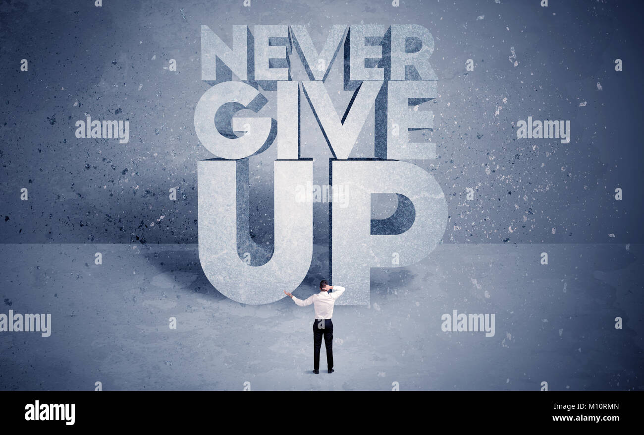 A stressed out business worker standing in front of huge block letters ...