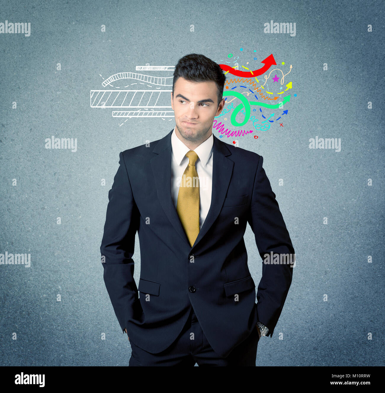 A handsome sales person standing in front of a blue urban concrete wall ...