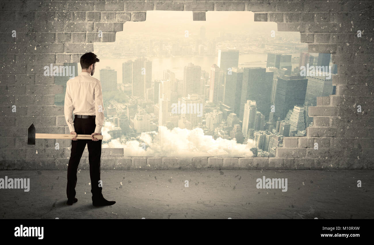 Business man hitting wall with hammer on city view background Stock ...