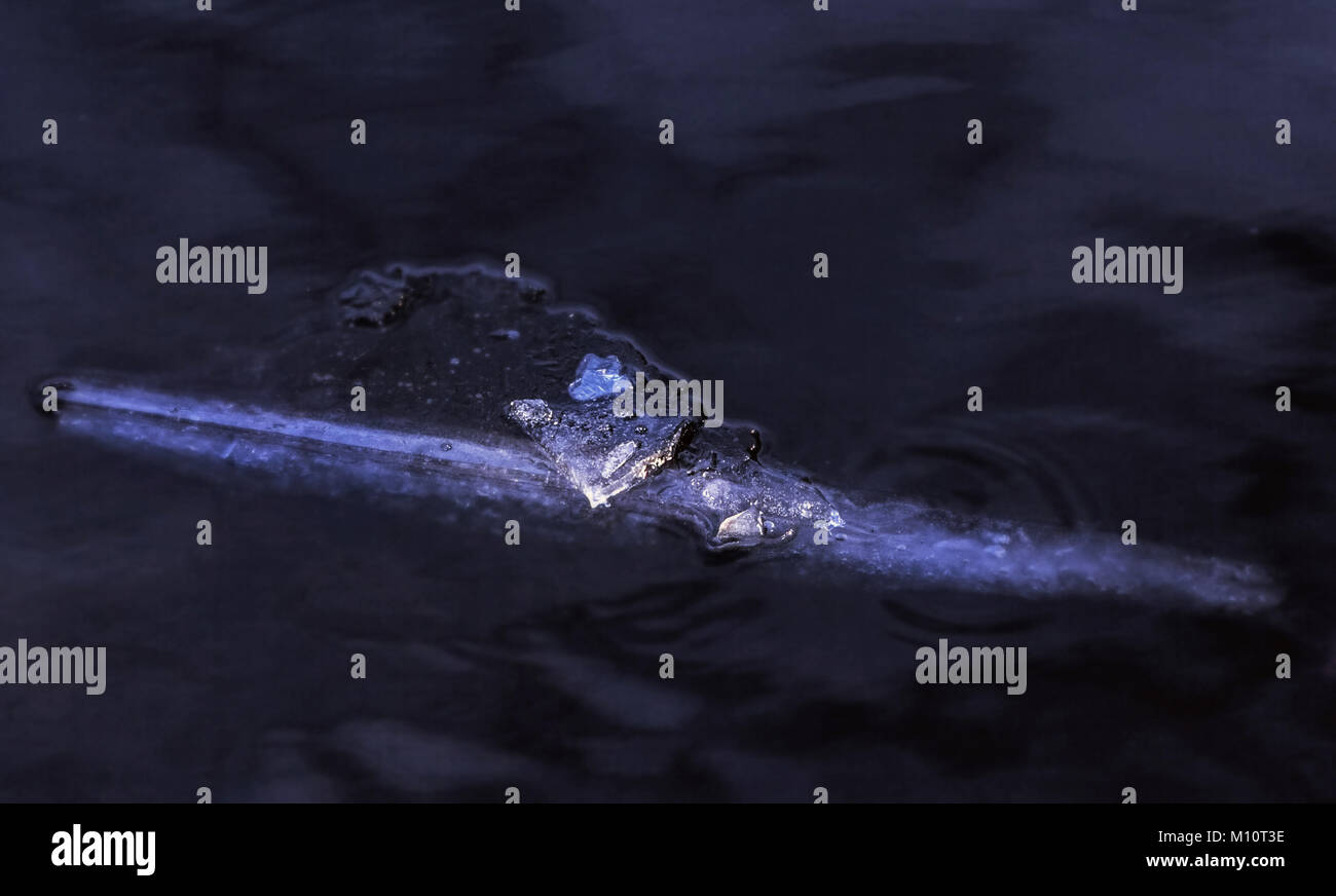 Ice in dark deep winter water at cloudy weather Stock Photo - Alamy