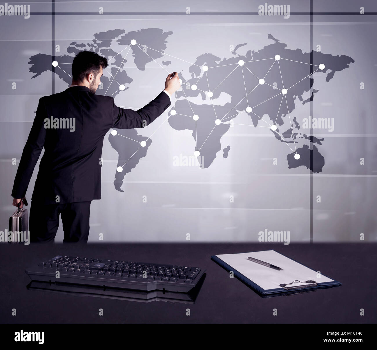 A young office worker drawing on world map and connecting dots with ...
