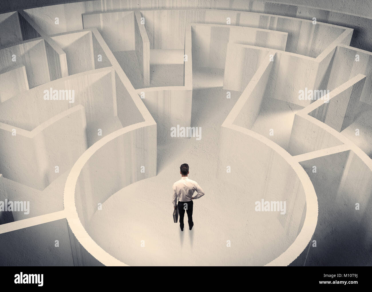 A confused businessman standing in the center of a maze surrounded with ...