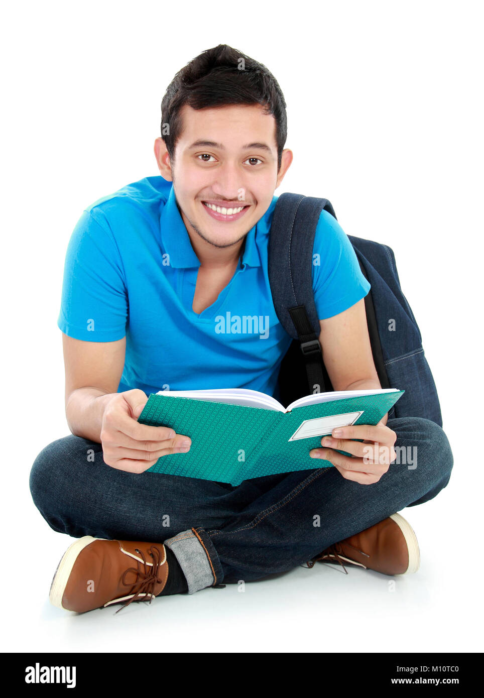 Happy smiling college student sit on the floor reading a book Stock ...