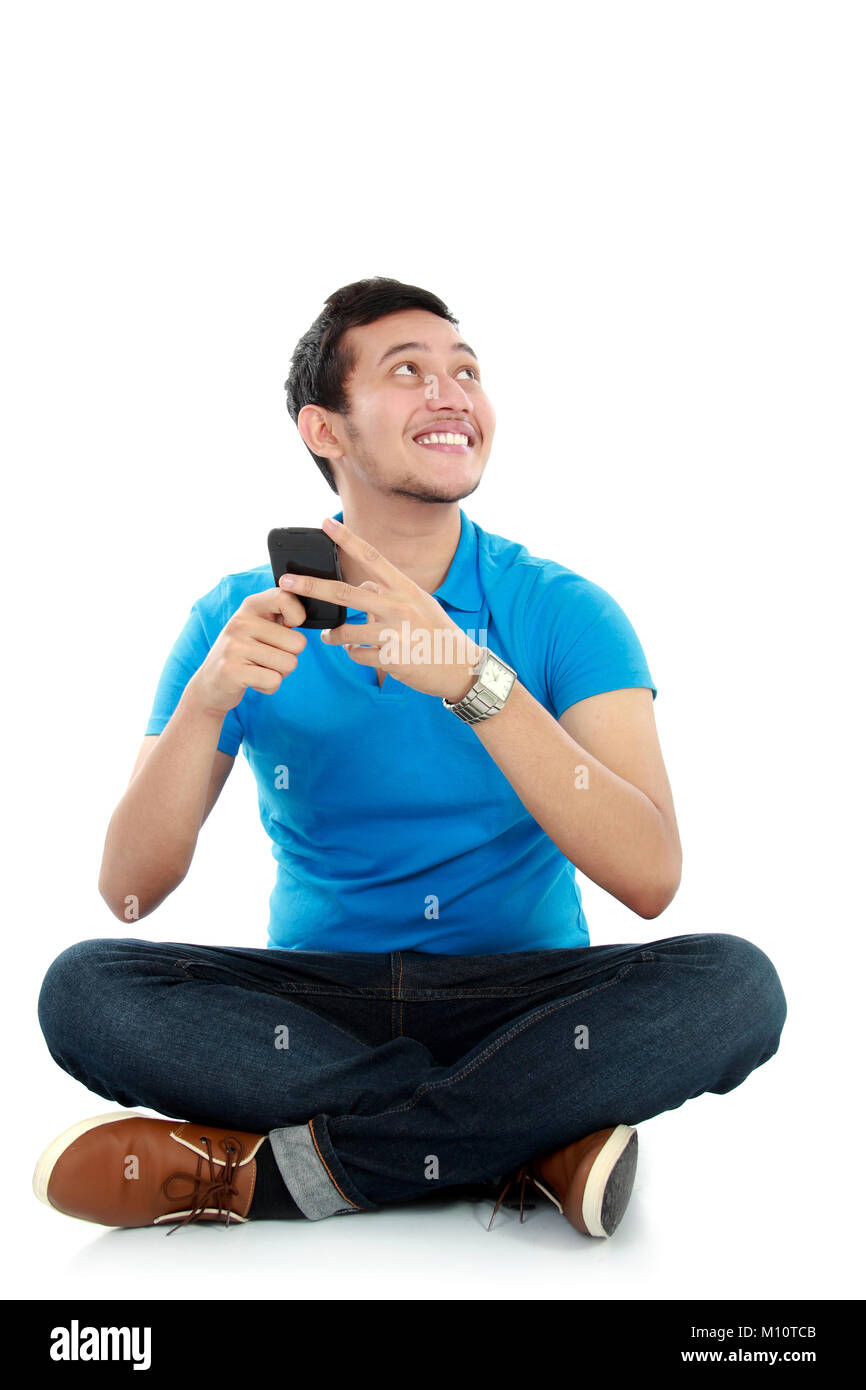 young asian man texting message and thinking with blank space Stock ...