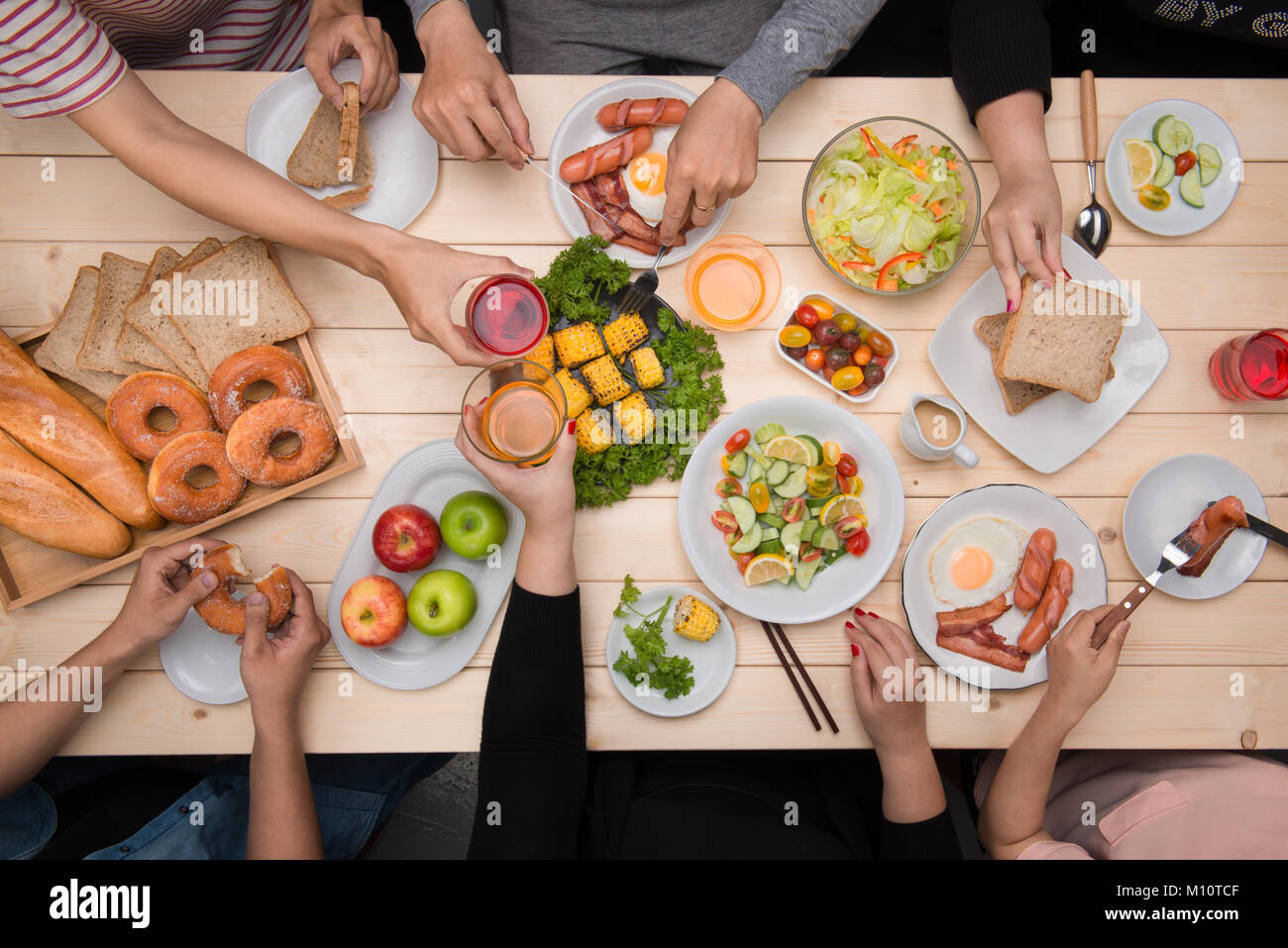 Enjoying dinner with friends. Top view of group of people having dinner ...